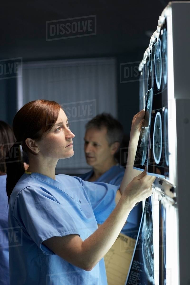 Doctor looking at x-rays - Royalty-free Stock Photo | Dissolve