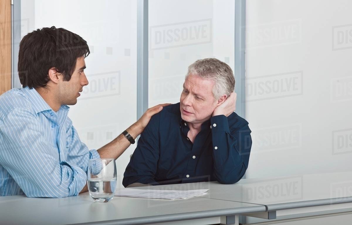 Man consoling work colleague - Royalty-free Stock Photo | Dissolve