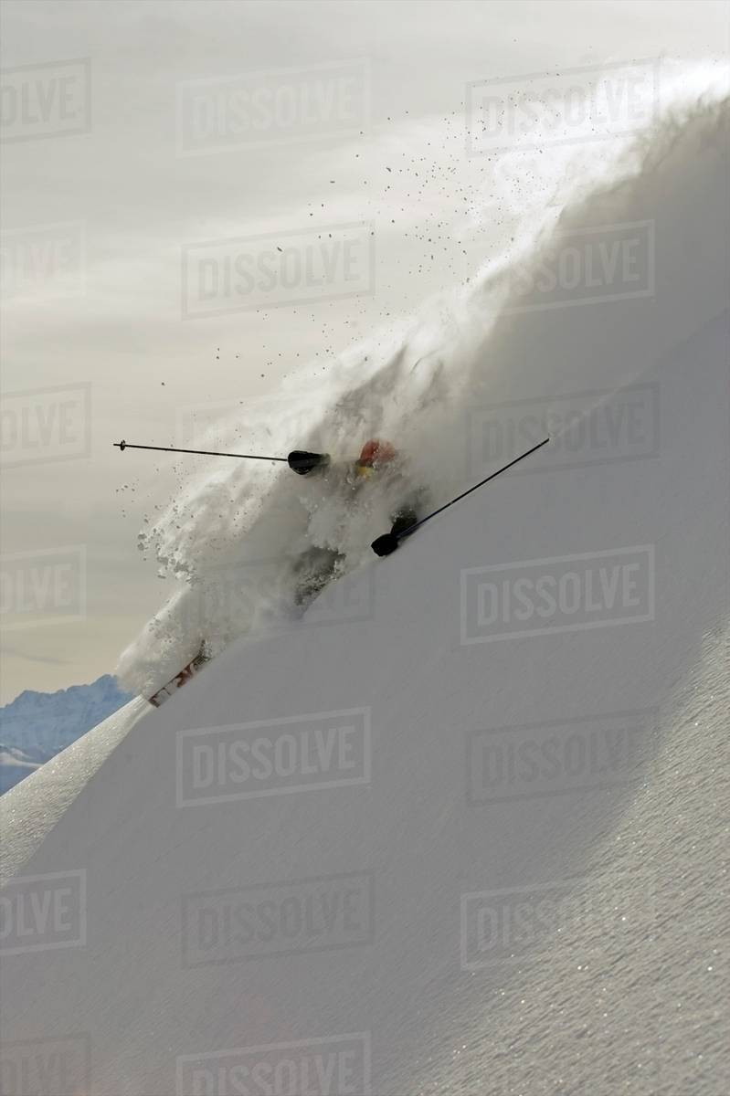 Skier turning in deep powder snow. - Royalty-free Stock Photo | Dissolve