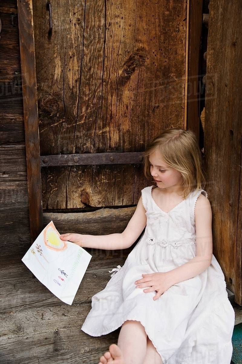 Girl in white reading. - Royalty-free Stock Photo | Dissolve