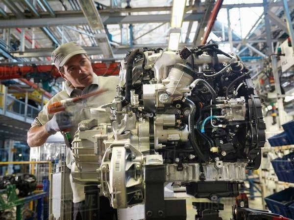 Car Worker Building Car Parts - Stock Photo - Dissolve