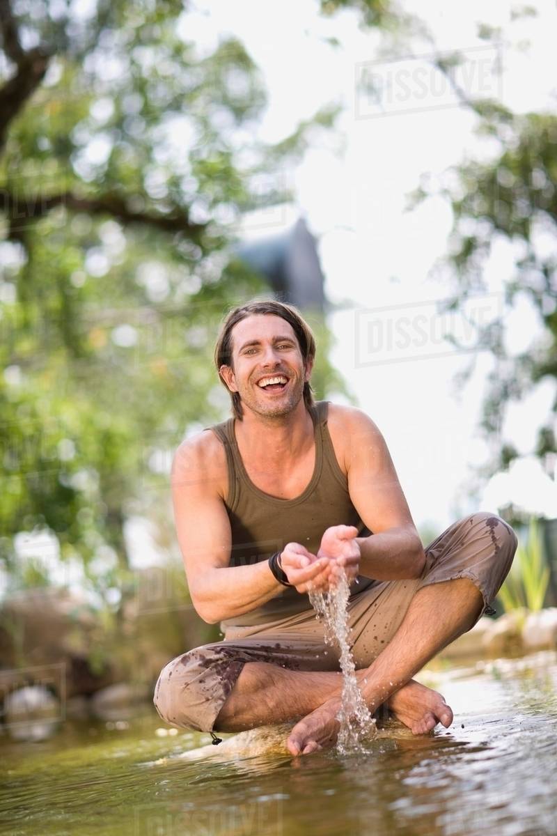 Man sitting in a river - Royalty-free Stock Photo | Dissolve