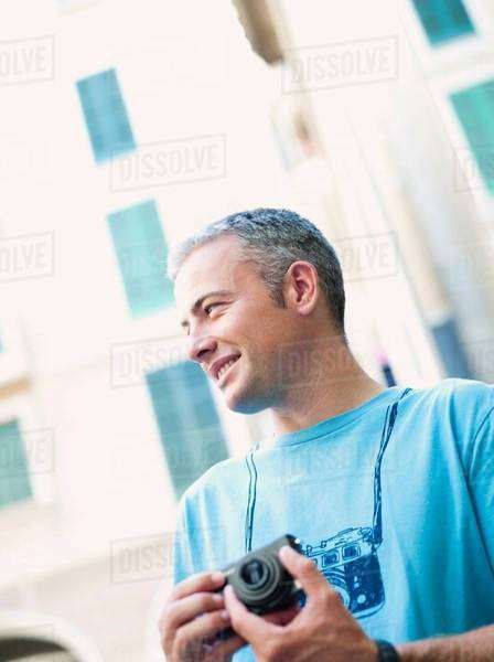 Man using camera - Royalty-free Stock Photo | Dissolve