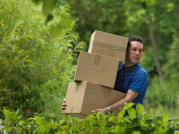 Man carrying boxes - Royalty-free Stock Photo | Dissolve