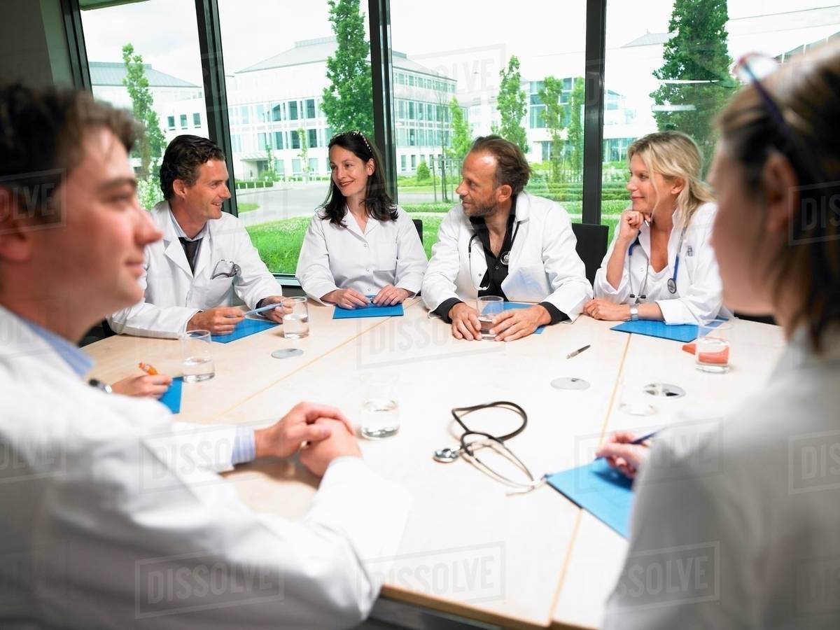 Doctors around a table - Stock Photo - Dissolve