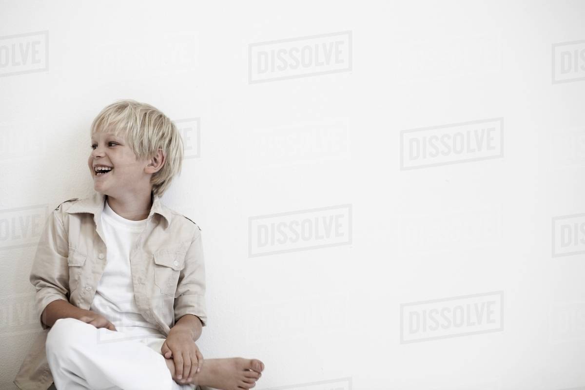 Portrait of young boy laughing - Stock Photo - Dissolve