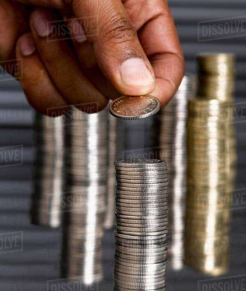 Man stacking sterling coins - Royalty-free Stock Photo | Dissolve