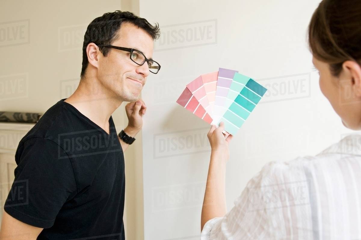 A female showing a male color swabs - Stock Photo - Dissolve