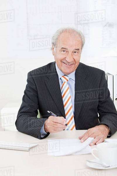 Senior executive signing document - Royalty-free Stock Photo | Dissolve