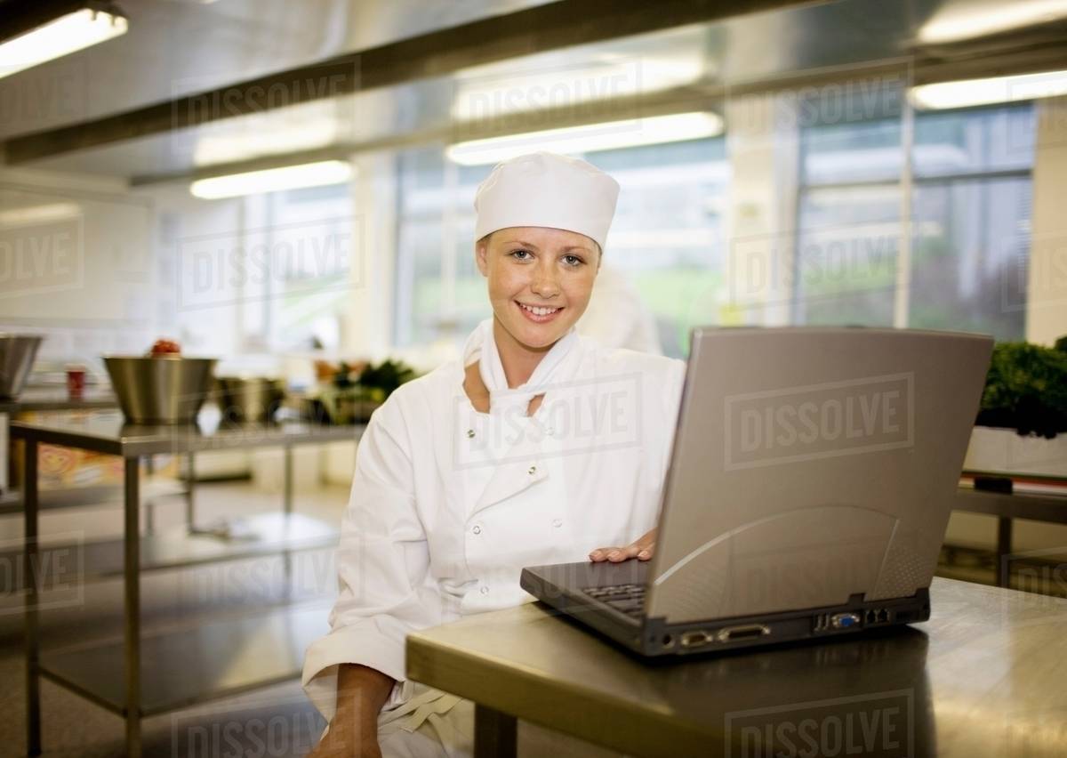 A chef working at her laptop - Royalty-free Stock Photo | Dissolve