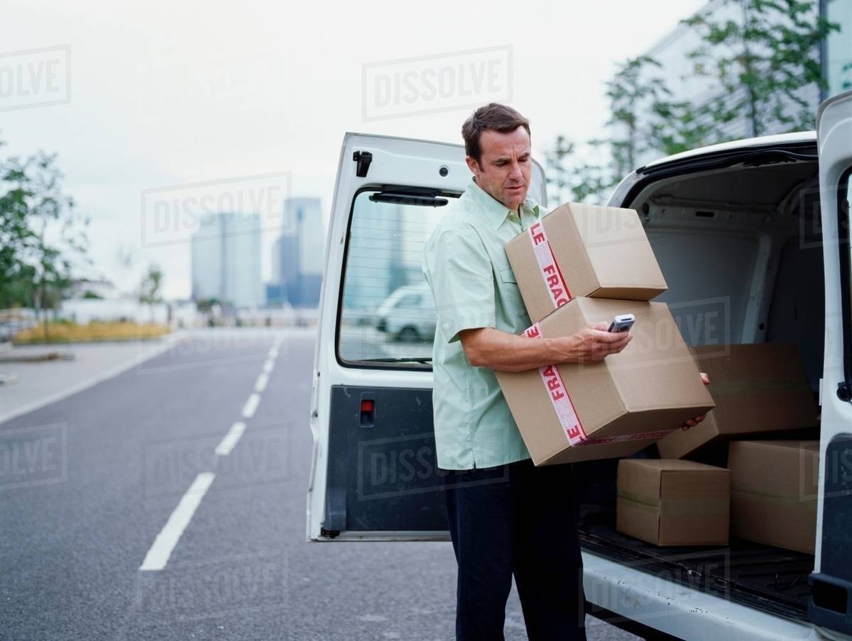 A courier delivers Parcels - Royalty-free Stock Photo | Dissolve