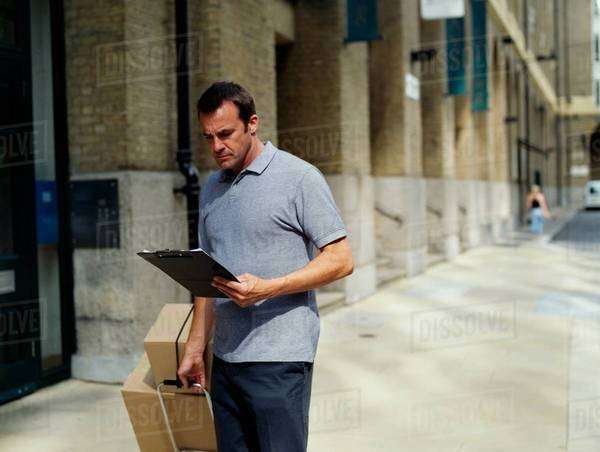A courier delivers parcels - Royalty-free Stock Photo | Dissolve