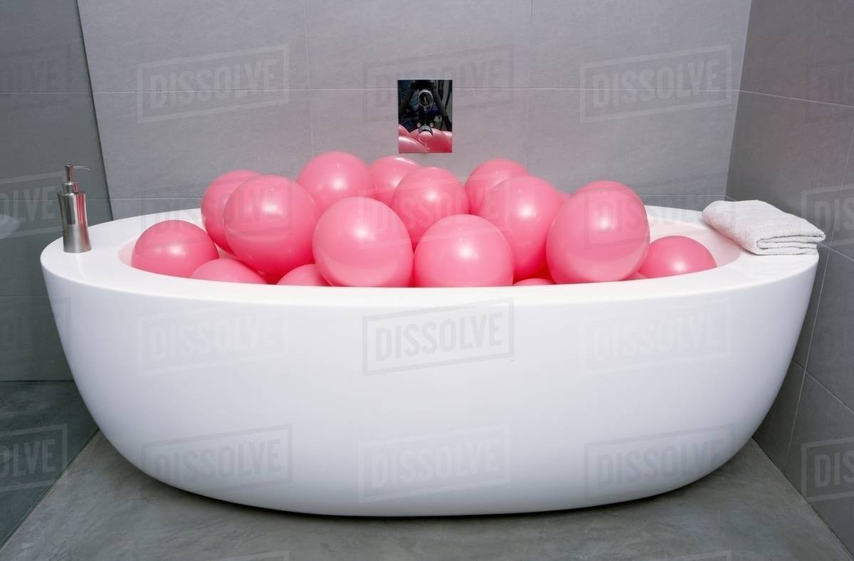 Bath filled with pink balloons - Royalty-free Stock Photo | Dissolve