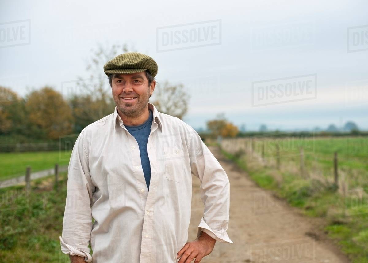 Farmer walking in country lane - Stock Photo - Dissolve