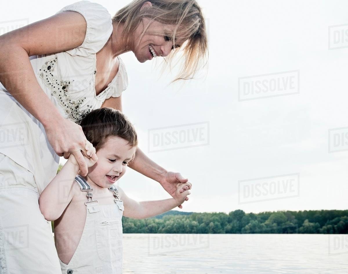 Mother helping child - Stock Photo - Dissolve