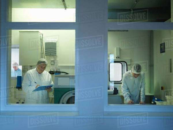 Laboratory Clean Room Technicians - Stock Photo - Dissolve