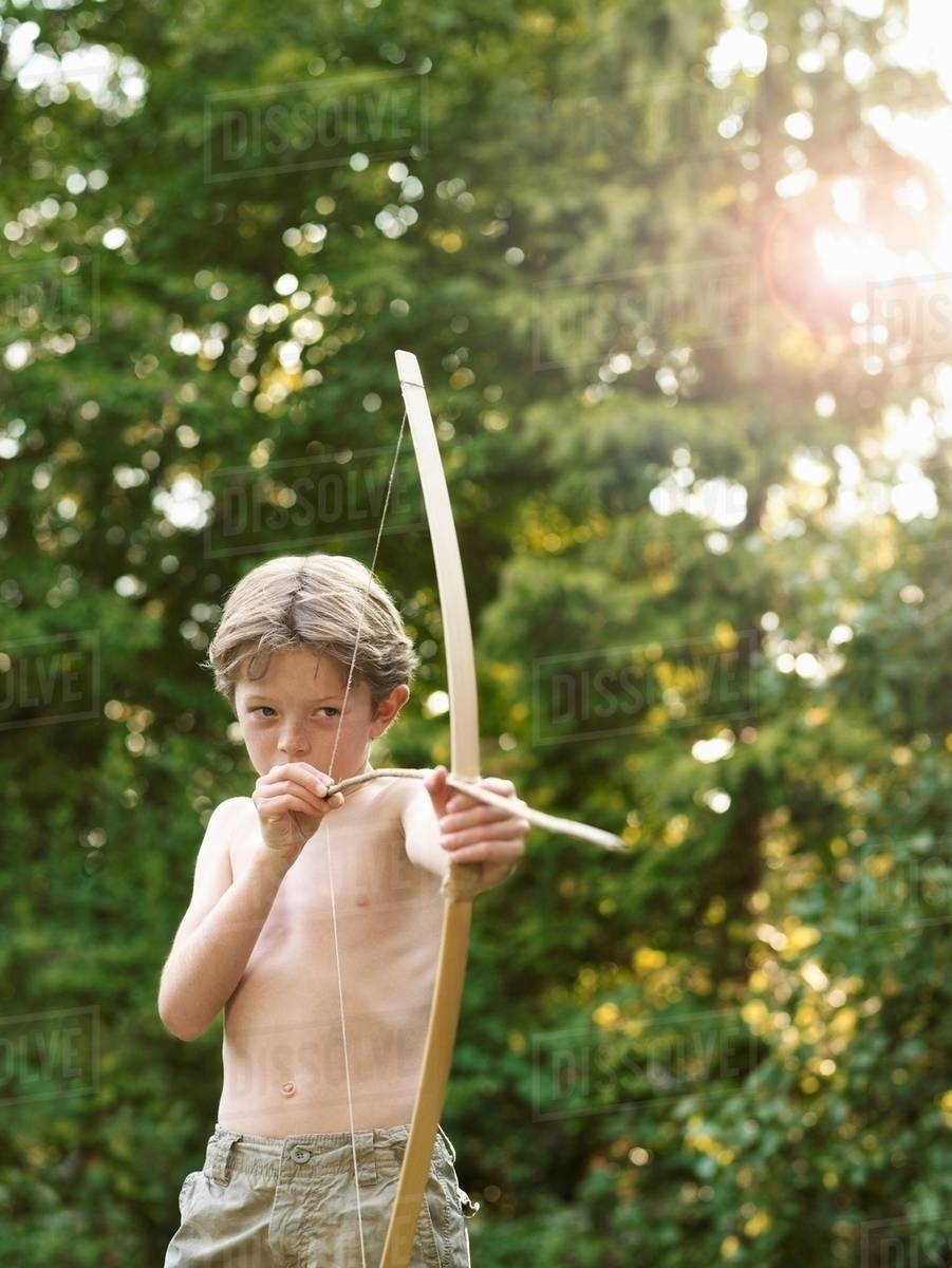 Young boy plays with bow and arrow - Royalty-free Stock Photo | Dissolve