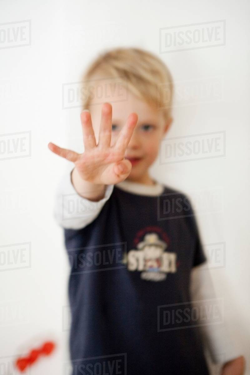 Boy pointing four fingers - Royalty-free Stock Photo | Dissolve