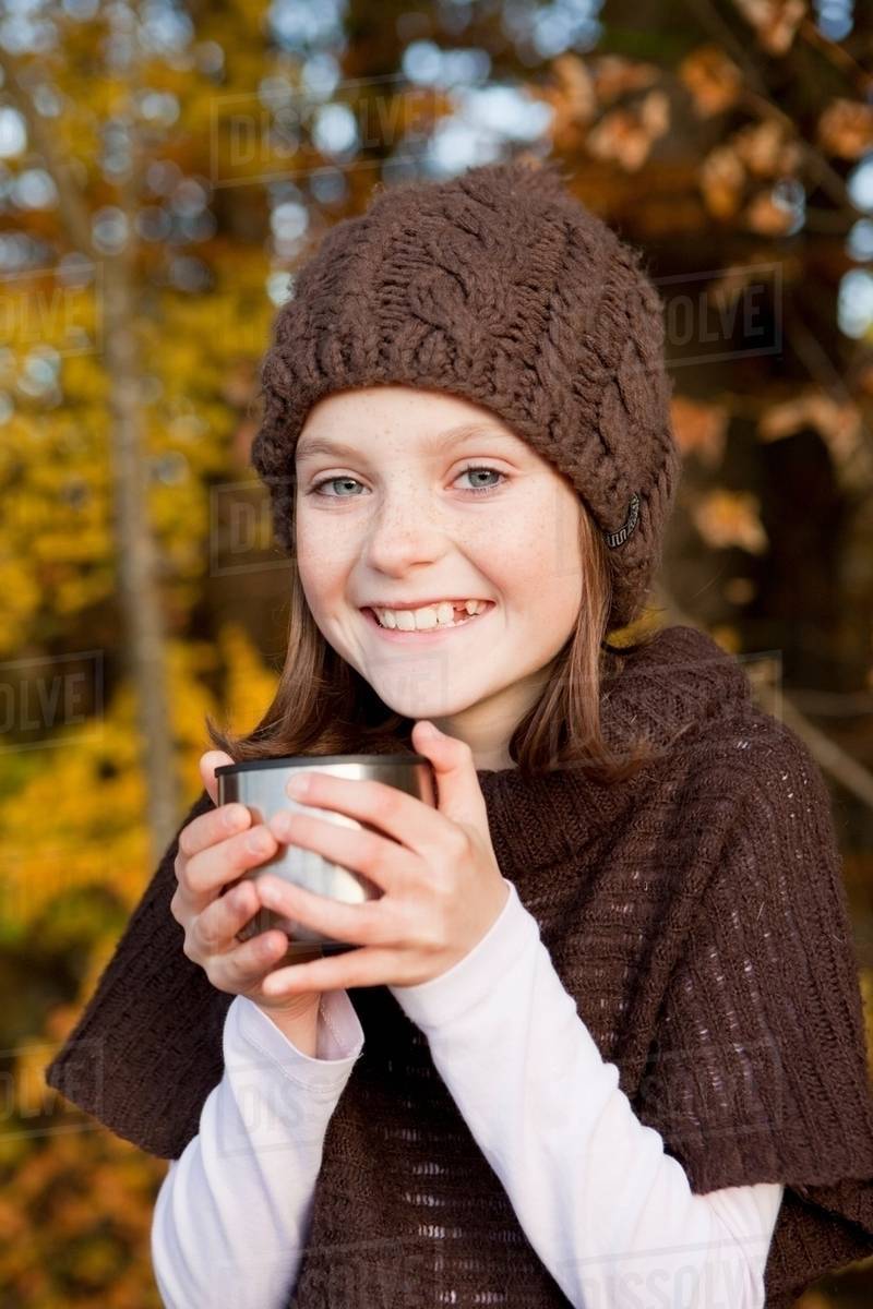 Girl drinking tea outside - Stock Photo - Dissolve