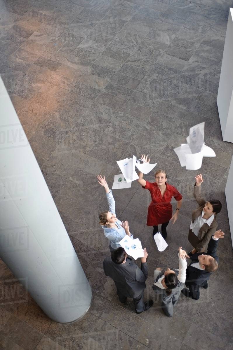 Business team throwing papers in the air - Stock Photo - Dissolve
