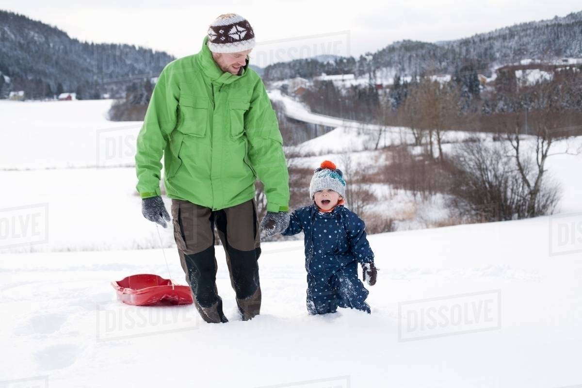Father and son playing in the snow - Royalty-free Stock Photo | Dissolve