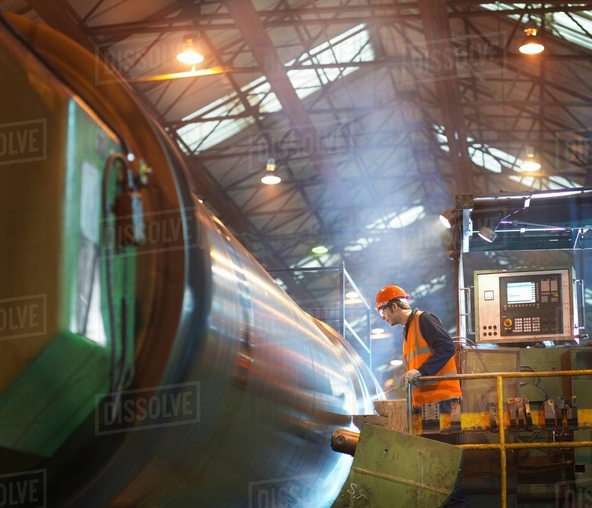 Steel Engineer Inspecting Lathe - Stock Photo - Dissolve