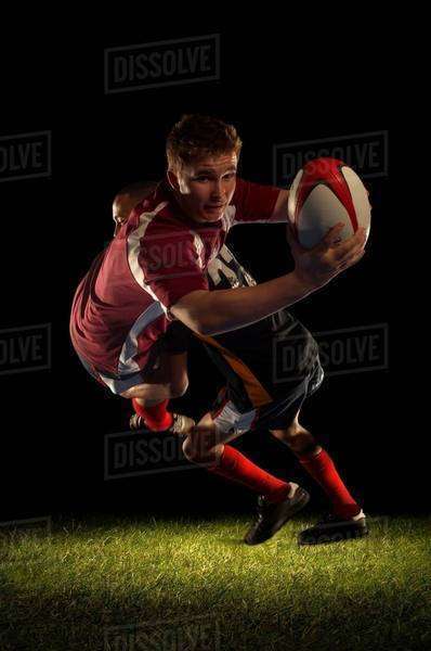 Rugby player being tackled and scoring - Stock Photo - Dissolve