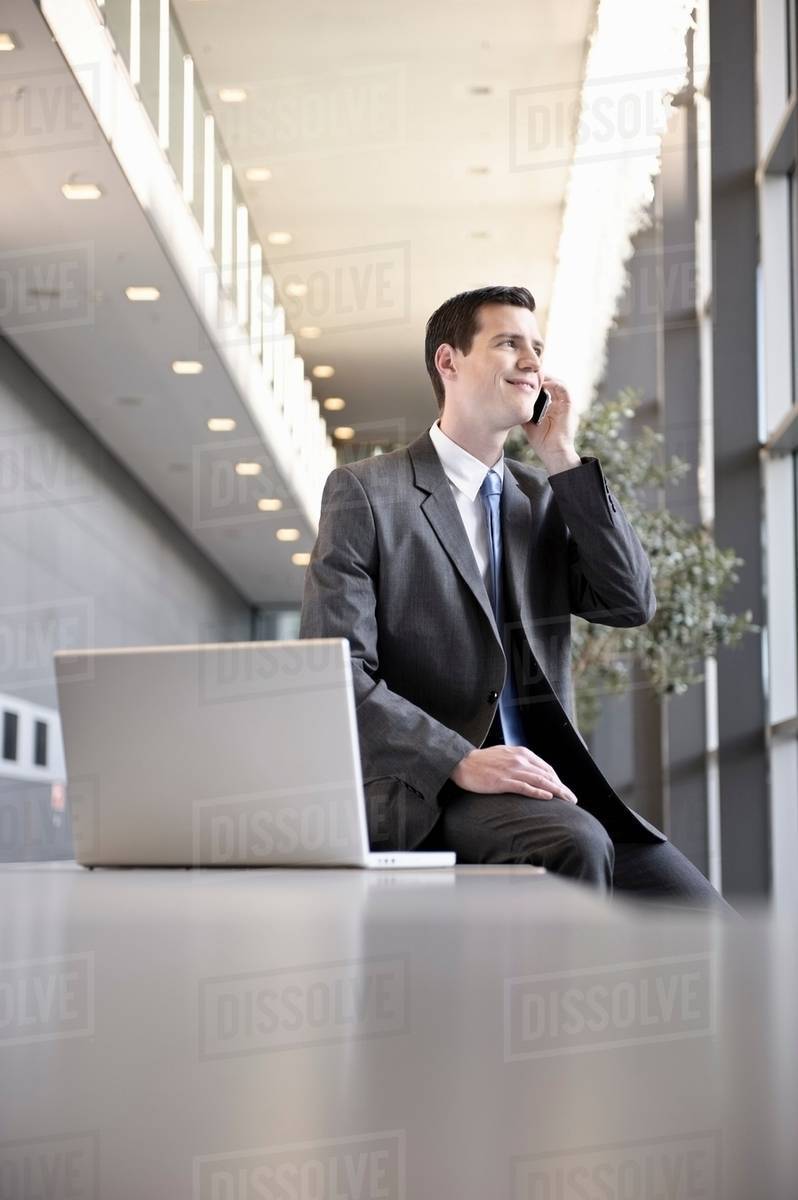 Businessman using cell phone - Stock Photo - Dissolve