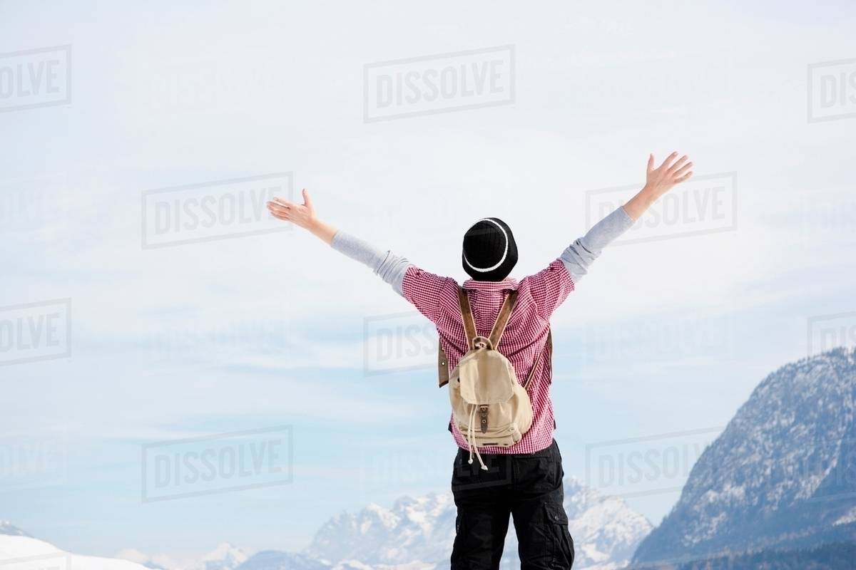 Man embracing sky - Stock Photo - Dissolve