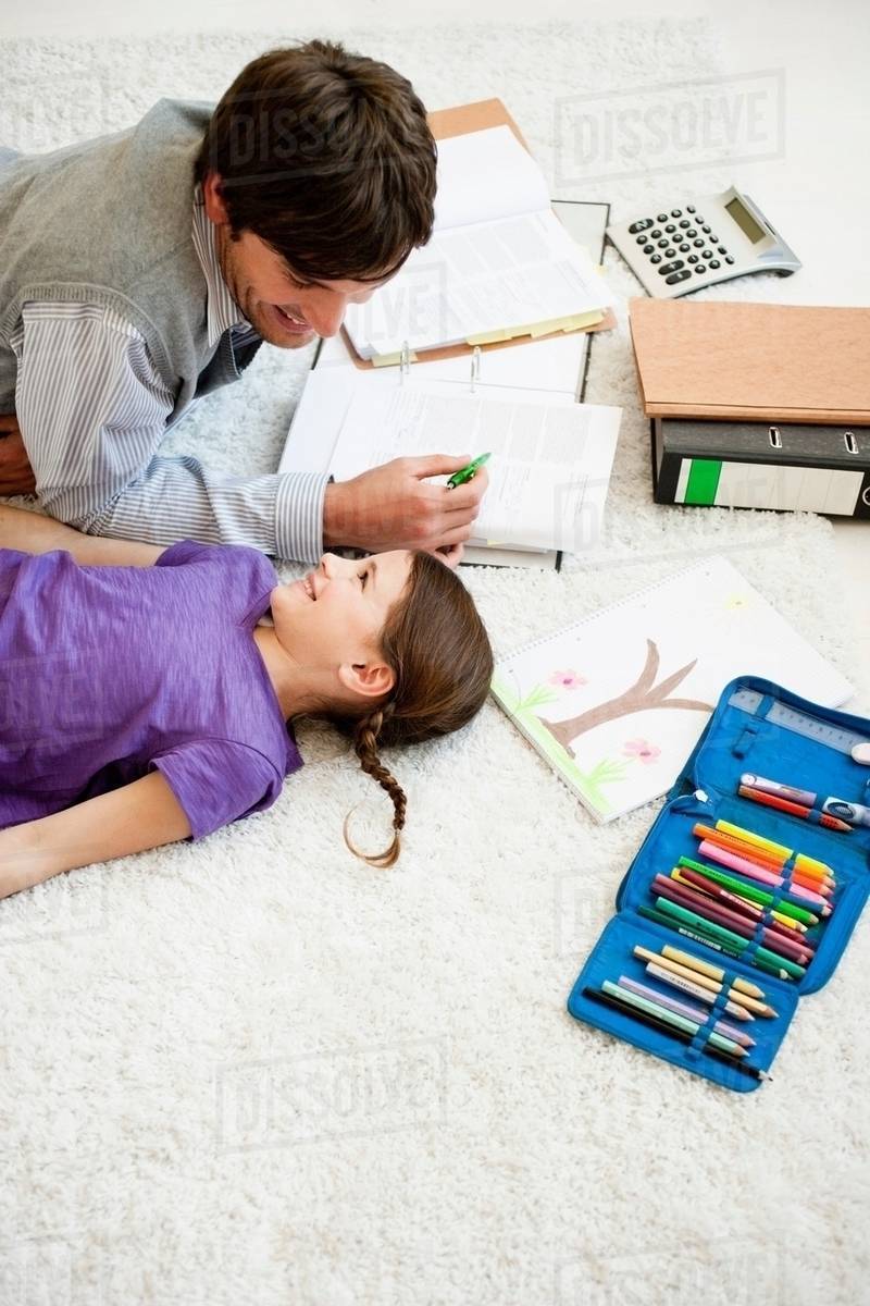Father and girl doing paperwork - Stock Photo - Dissolve