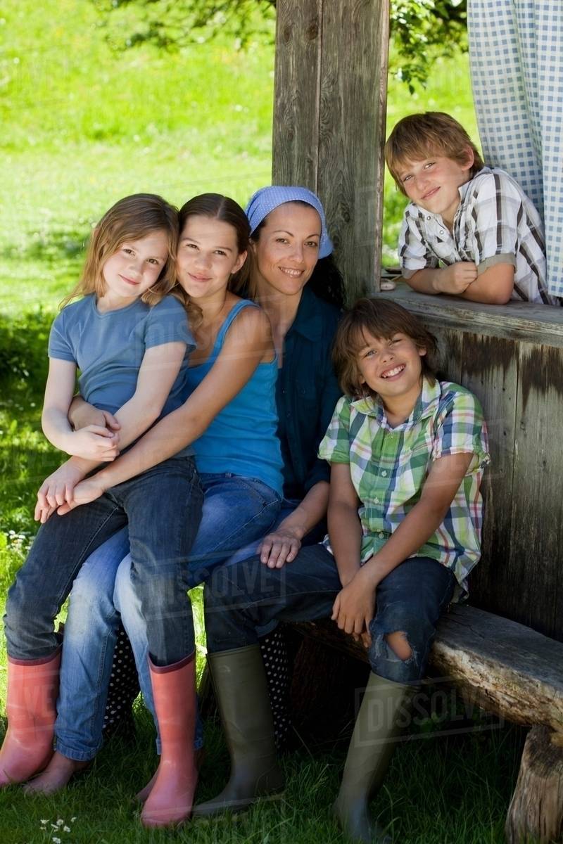 Family resting on shed, happy - Royalty-free Stock Photo | Dissolve