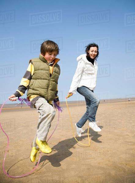 Mother and son with skipping ropes - Stock Photo - Dissolve