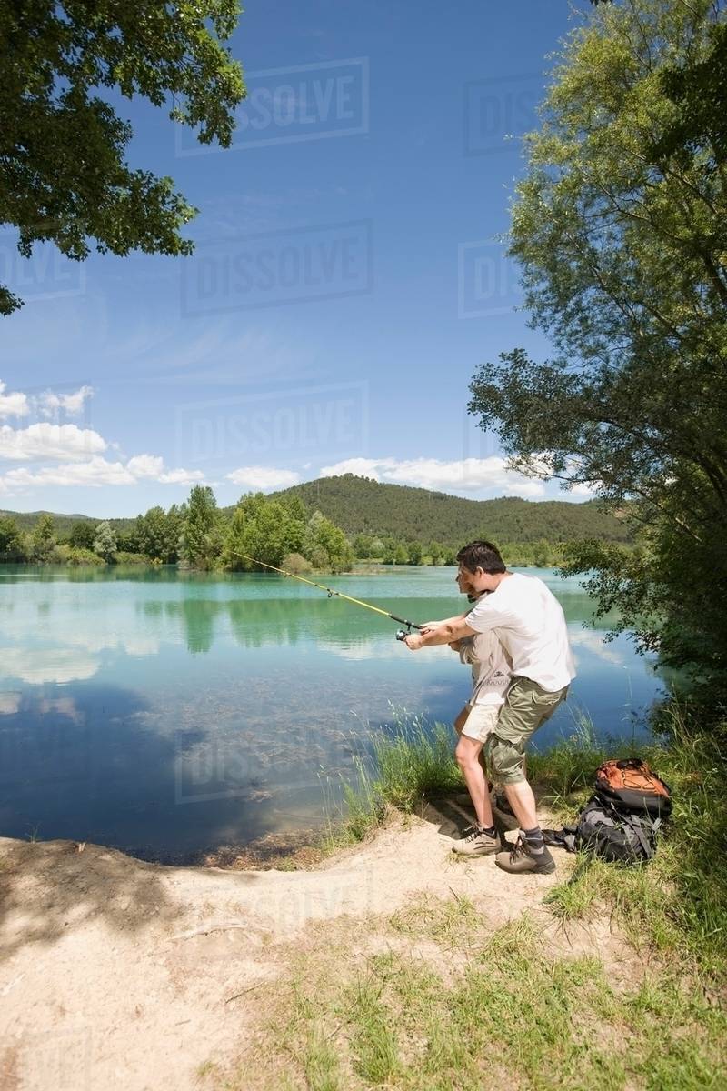 Couple trying to catch a fish - Royalty-free Stock Photo | Dissolve