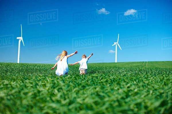 Childrens play in field & wind turbines - Royalty-free Stock Photo ...
