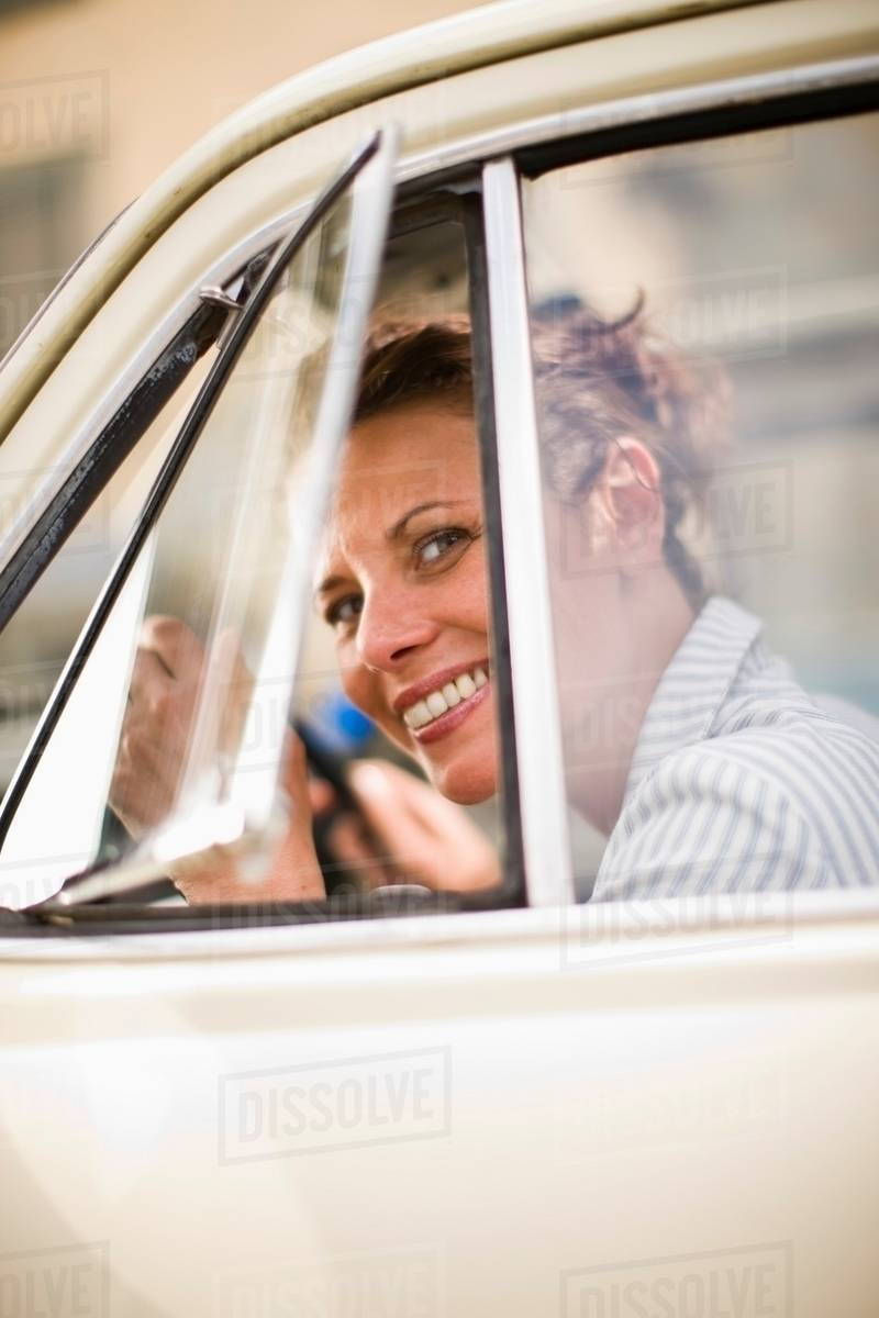Woman smiling in car - Stock Photo - Dissolve