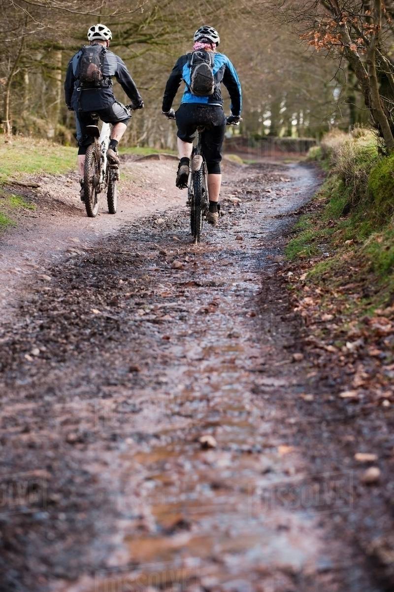 Couple mountain biking in countryside - Stock Photo - Dissolve
