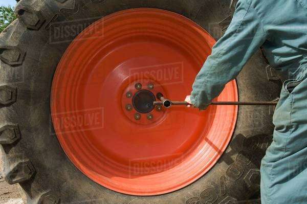 Changing tractor wheel - Royalty-free Stock Photo | Dissolve