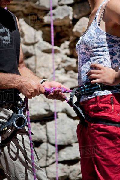 Rock climbers checking equipment - Royalty-free Stock Photo | Dissolve