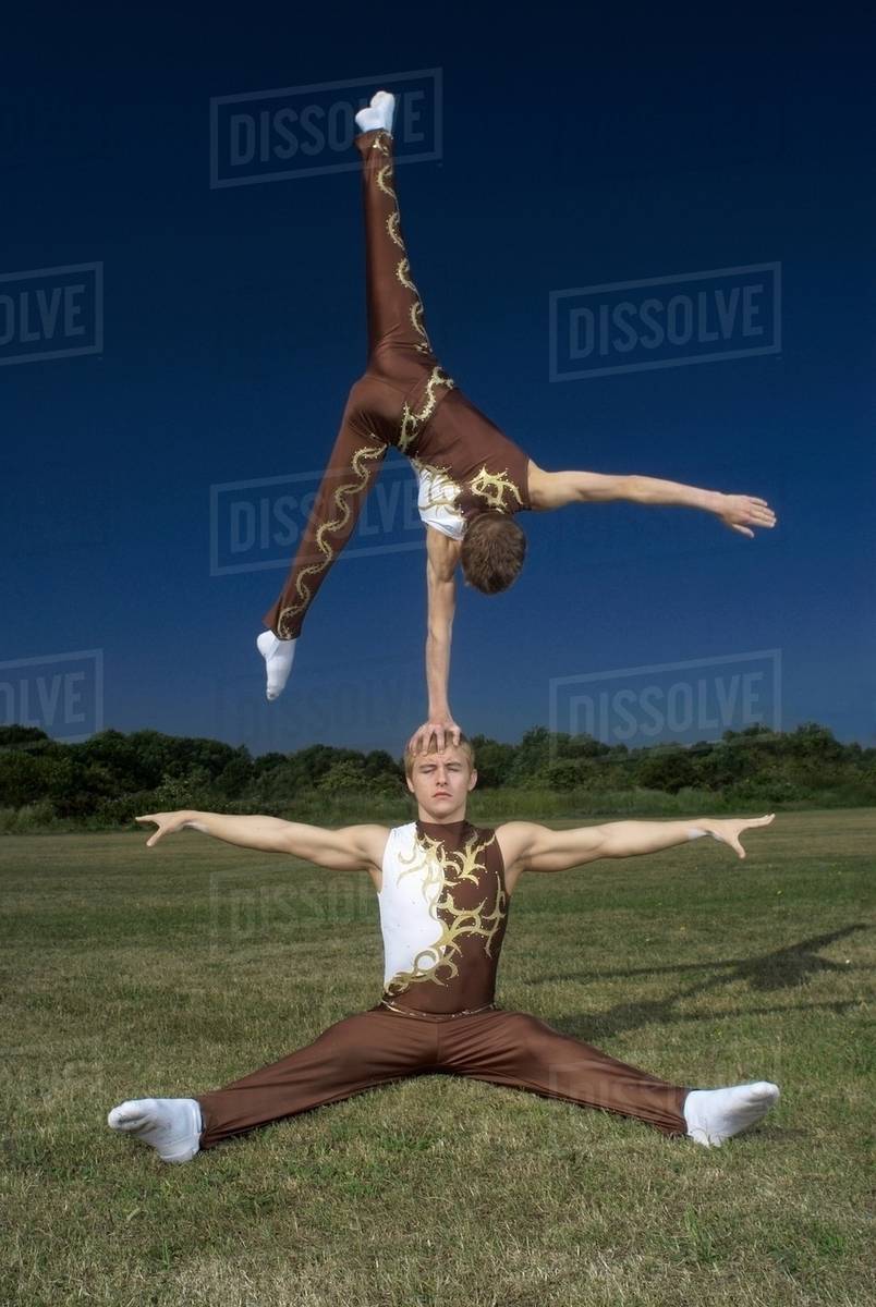 Acrobatic troop performing moves - Royalty-free Stock Photo | Dissolve
