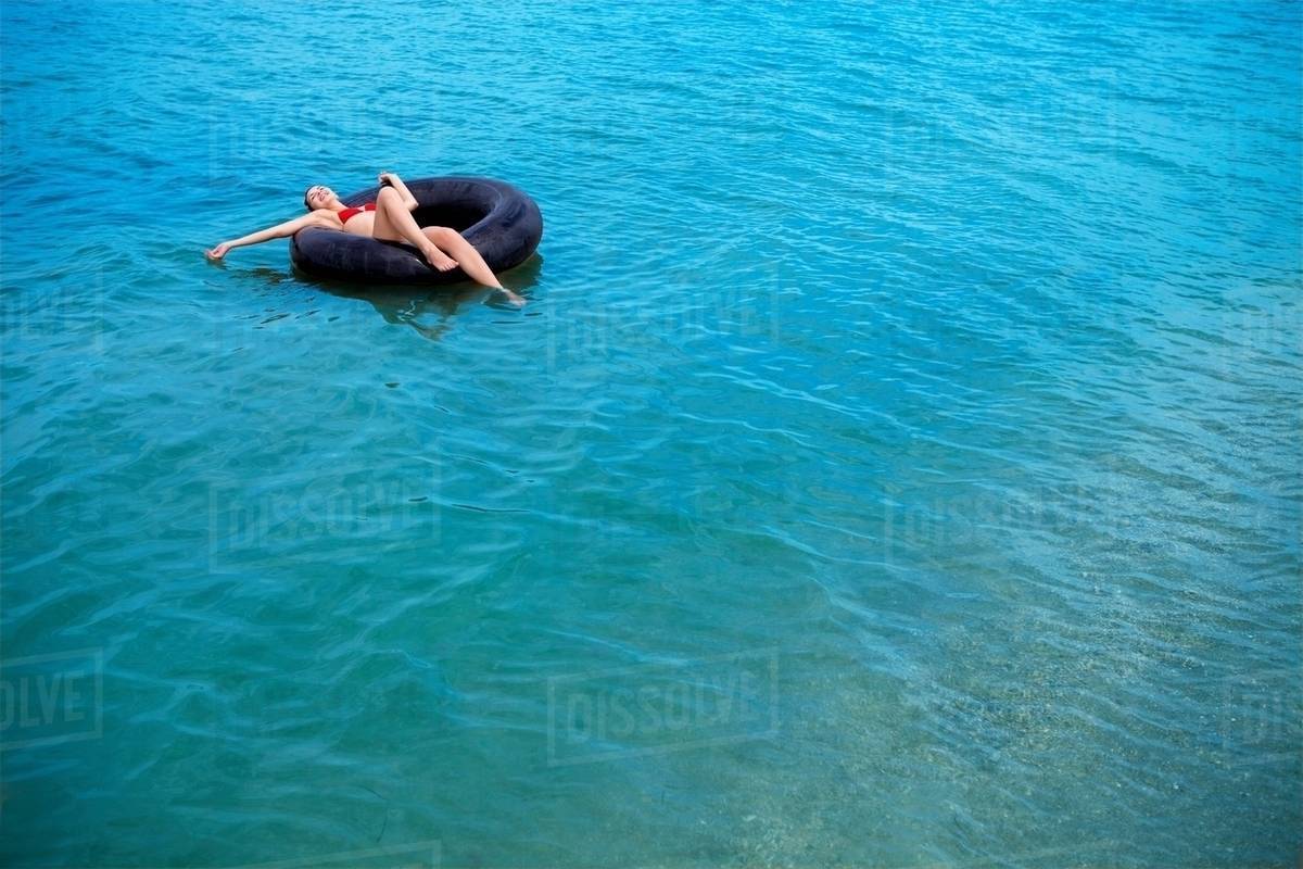 Woman swimming at the beach - Royalty-free Stock Photo | Dissolve