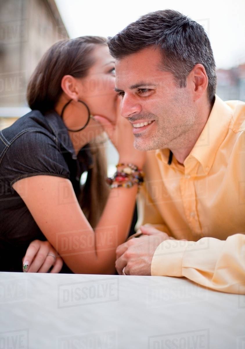 Couple whispering - Royalty-free Stock Photo | Dissolve