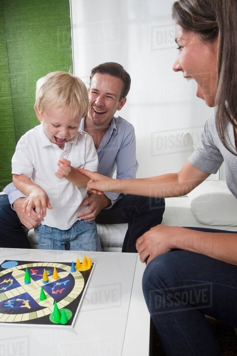 Family playing board game - Royalty-free Stock Photo | Dissolve