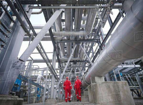 Workers walk through an underground gas - Stock Photo - Dissolve