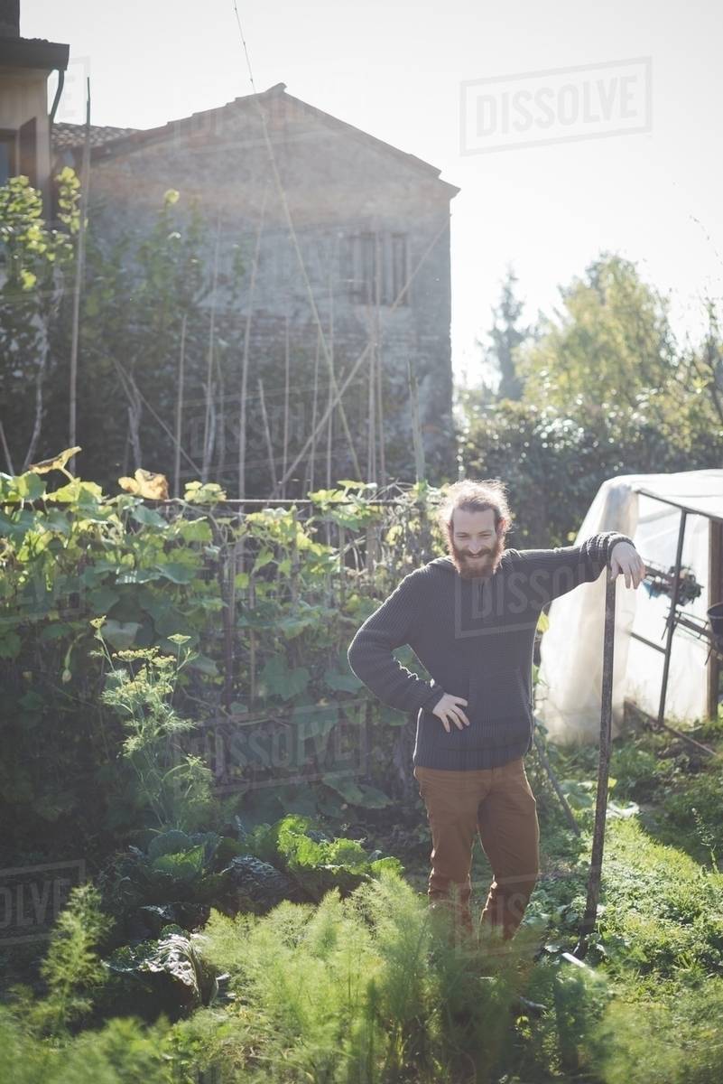 Young man in garden, portrait - Royalty-free Stock Photo | Dissolve