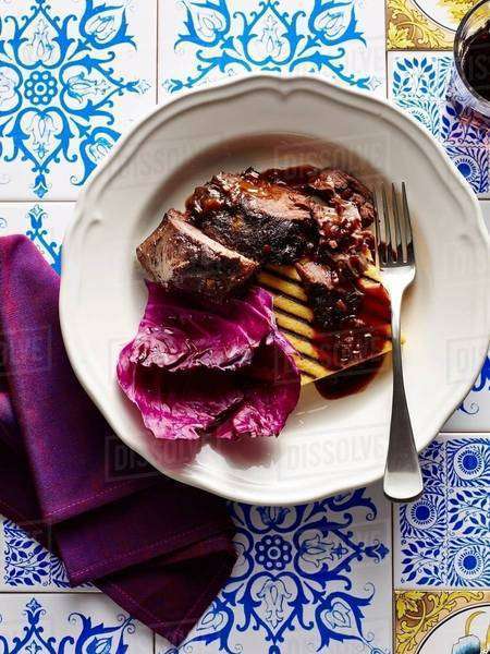 Still life with bowl of Italian braised veal cheeks and polenta ...