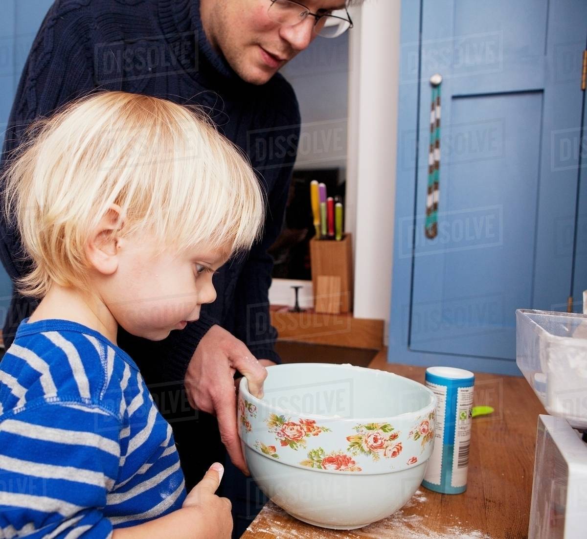 Father baking with son in kitchen - Royalty-free Stock Photo | Dissolve