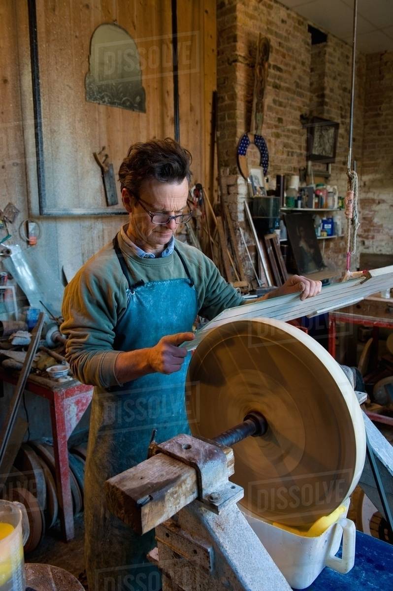 Glass engraver examining glass material in workshop - Stock Photo ...