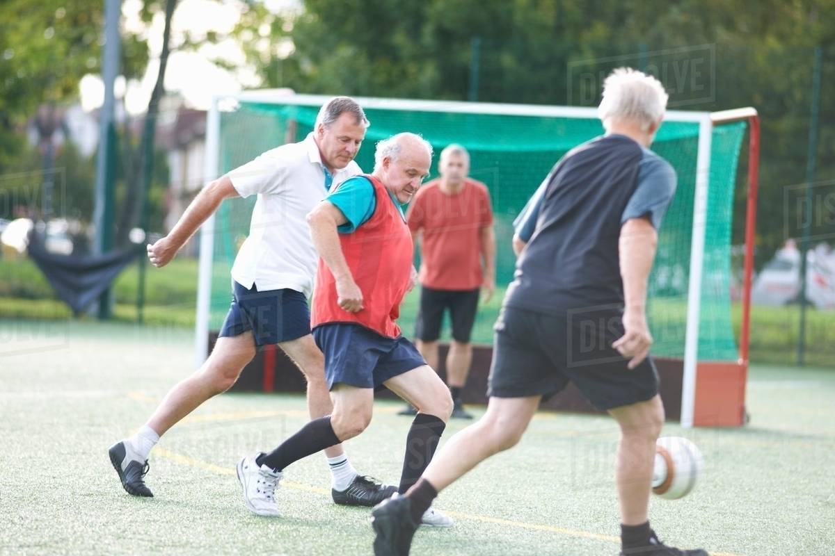Men playing football - Stock Photo - Dissolve