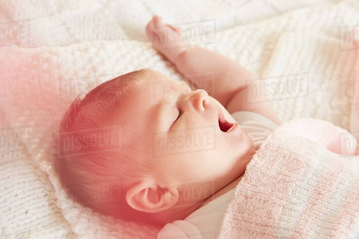 Baby yawning in sleep - Royalty-free Stock Photo | Dissolve