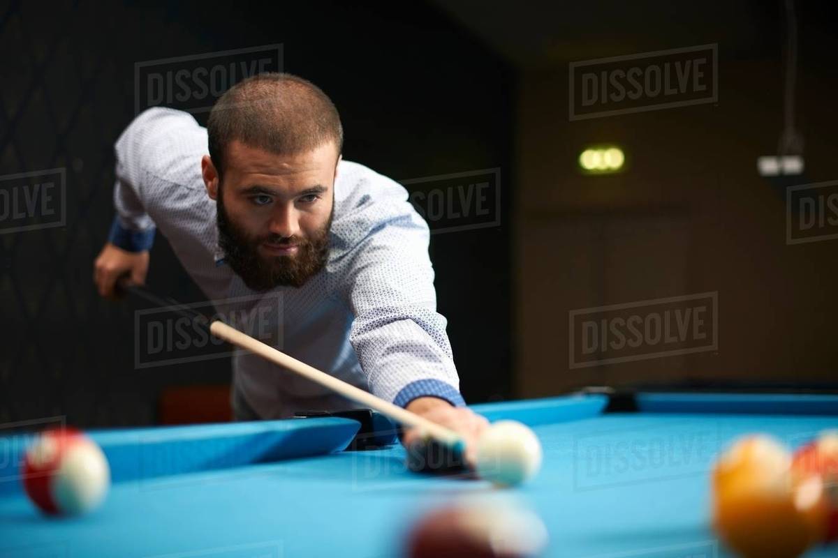Man playing pool in club - Royalty-free Stock Photo | Dissolve